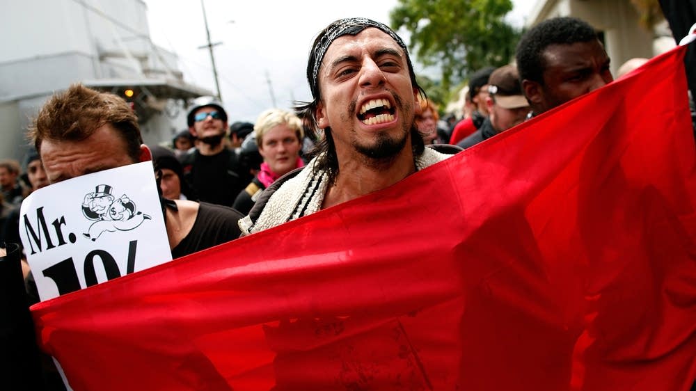 Photos: Protesters march through rain-soaked Tampa | MPR News