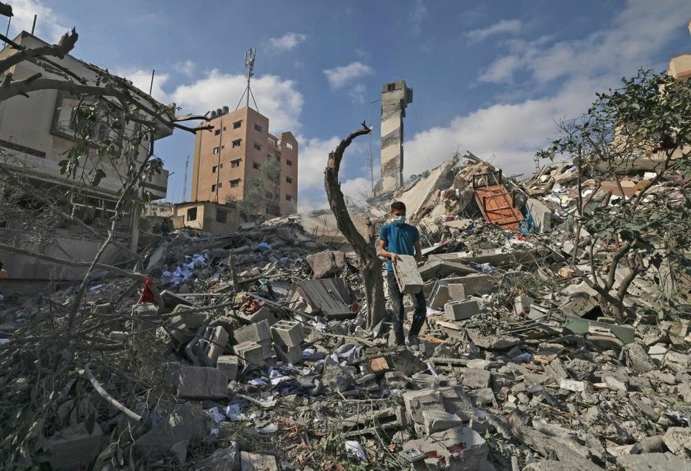 Strike from Gaza kills 2 as Israel topples 6-story building | MPR News