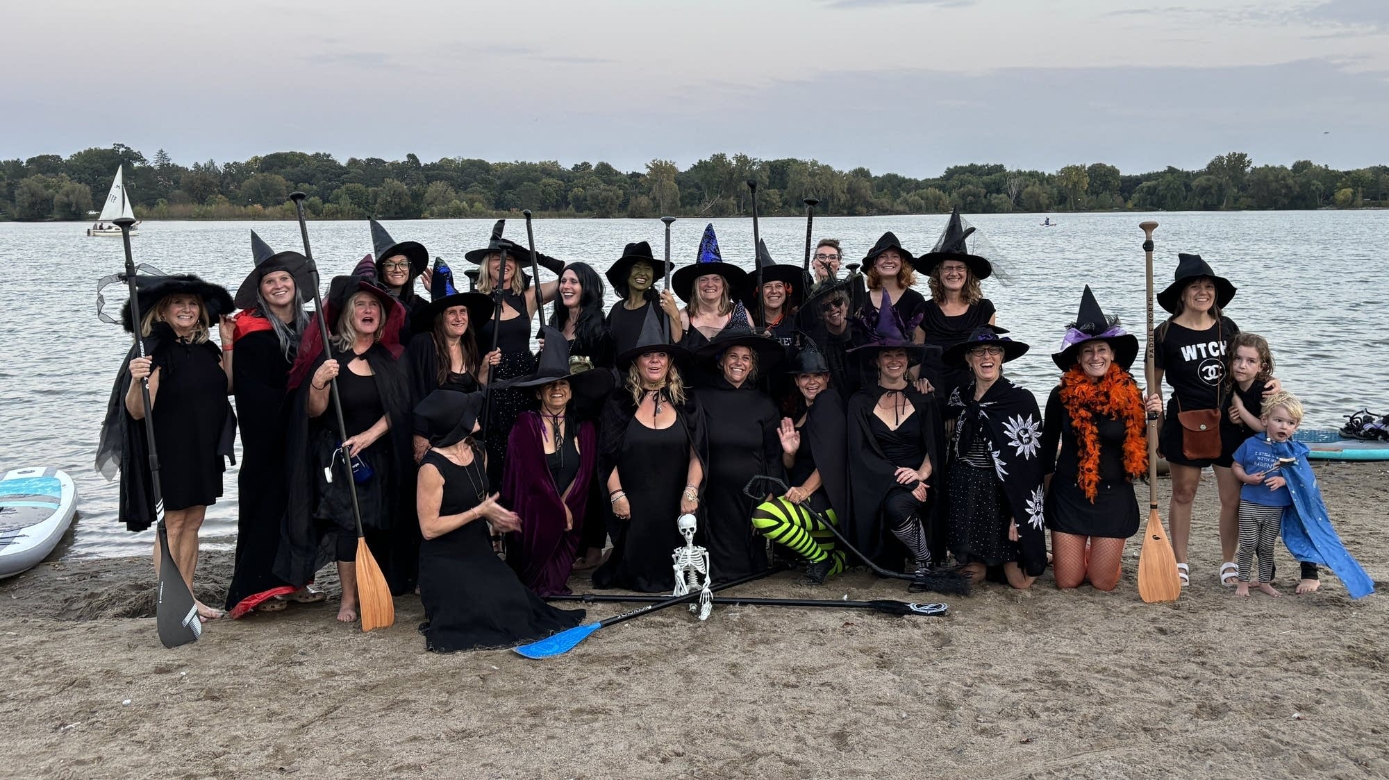 Group dressed as witches paddleboard Lake Nokomis in Minneapolis | MPR News