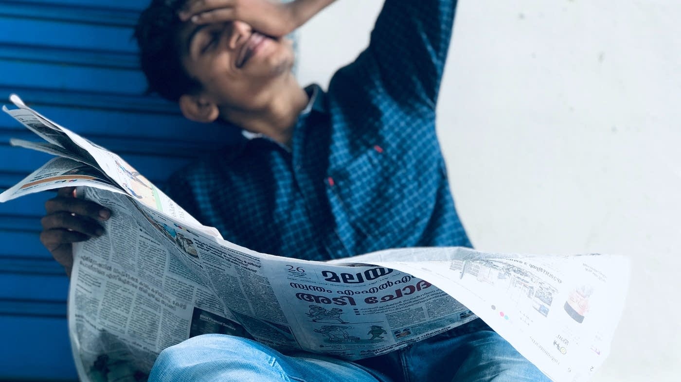 Kid Reading Newspaper