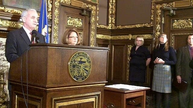 Dayton signs MA order as spirited crowd watches | MPR News