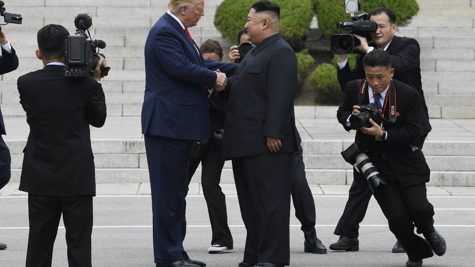 Wide grins and historic handshake for Trump, Kim at DMZ | MPR News