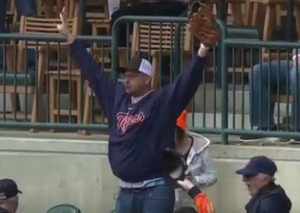 Fan catches 5 balls at a game, gives them all to kids | MPR News