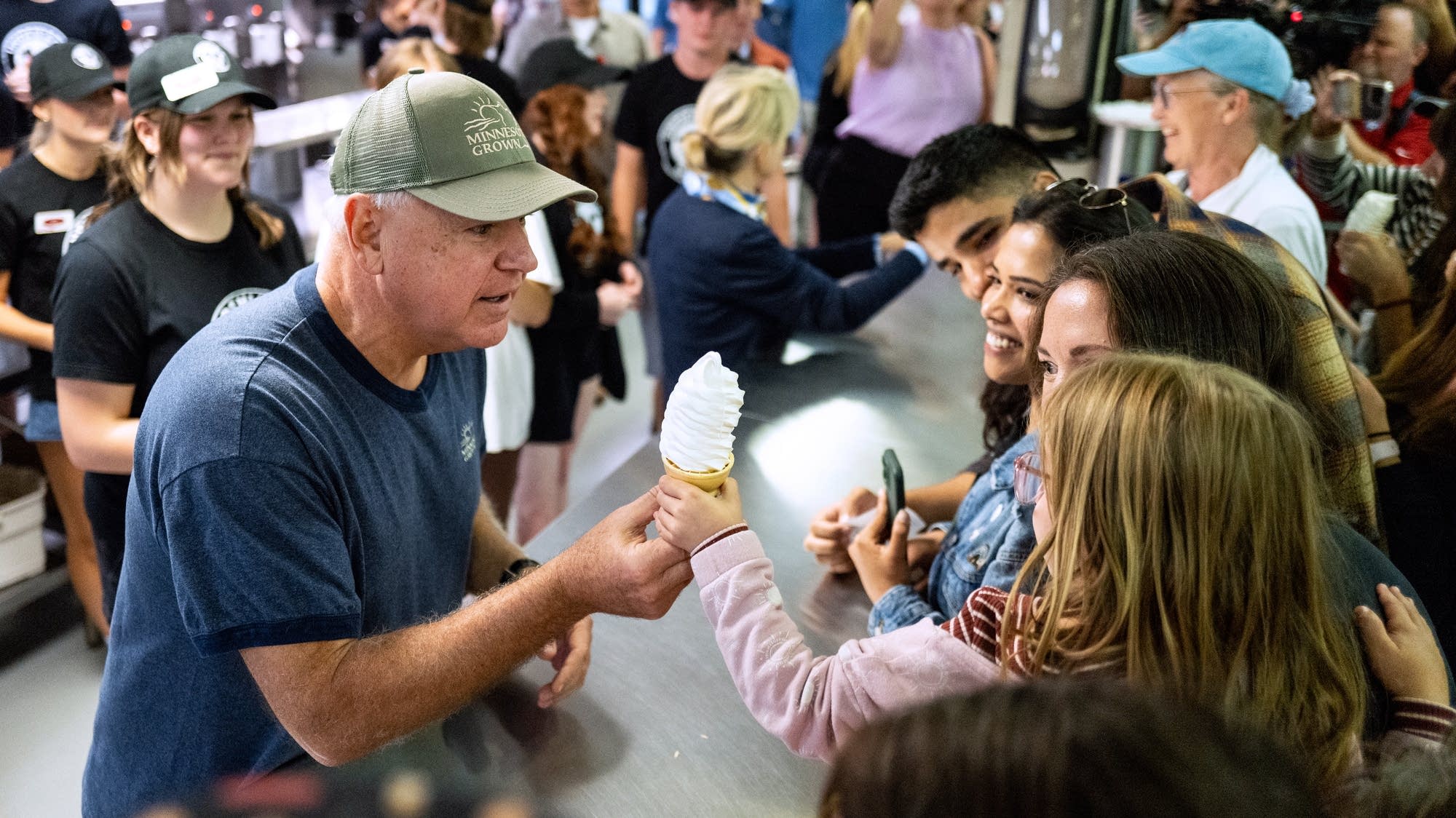 Gov. Walz campaigns at Minnesota State Fair, eats pork chop and serves ...