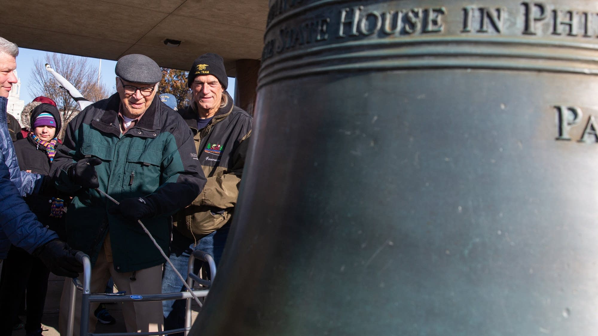 Two ex-governors help bring big bell to life to honor veterans | MPR News